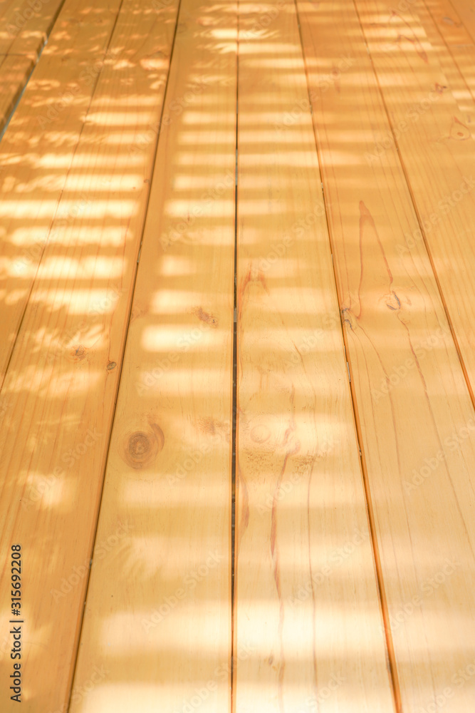 Light Wood boards are arranged in the roll with sunlight shine through ...