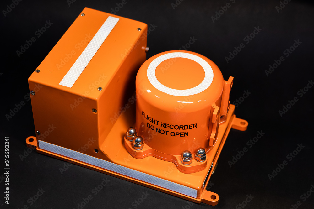 Aircraft flight data recorder on black background. Black Box in orange ...