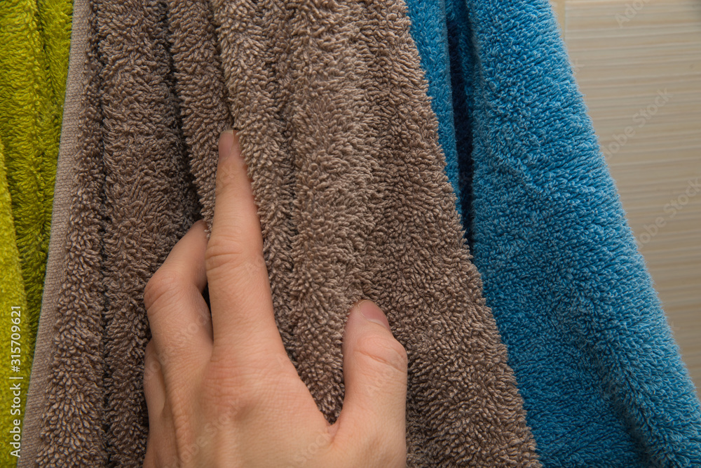 Wiping hands in a towel. The concept of caring for hands cleanliness ...