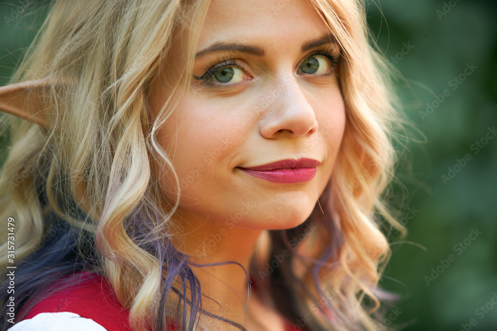 beautiful elf girl in nature. portraits of summer on a background of ...