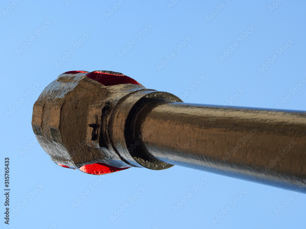 Barrel of a large-caliber gun, muzzle brake of a howitzer gun close-up ...