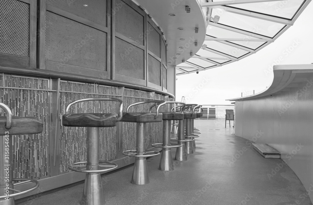 Wooden pool bar counter with stuhls on cruiseship or cruise ship liner ...