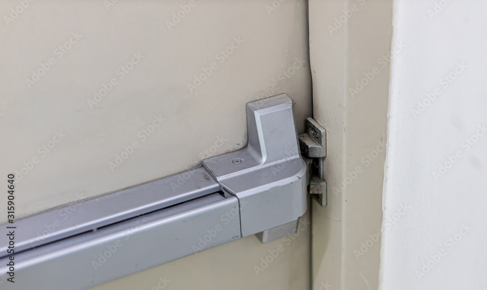 Emergency fire exit door. Closed up latch and rusty door handle of ...