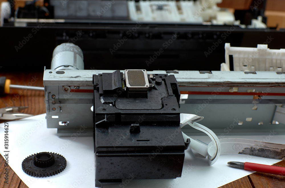 Printer disassembled into parts. Repair of the printer. Print head of ...