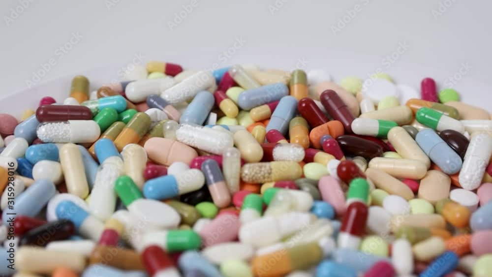 Pile of colorful medication pills rotating in a seamless loop Stock ...