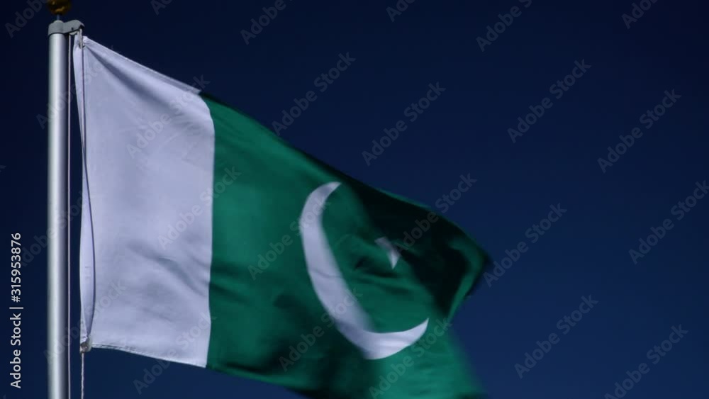 Pakistan Flag flying in the wind outdoors with Blue sky behind ...