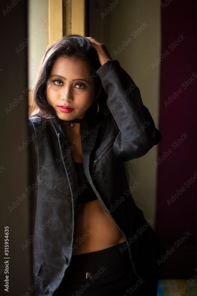 Fashion portrait of an young Indian Bengali brunette woman in black ...