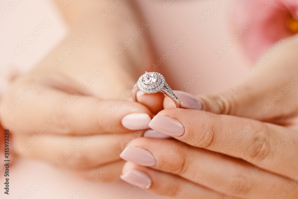 Close up of woman's hand holding elegant diamond ring. Stock Photo ...