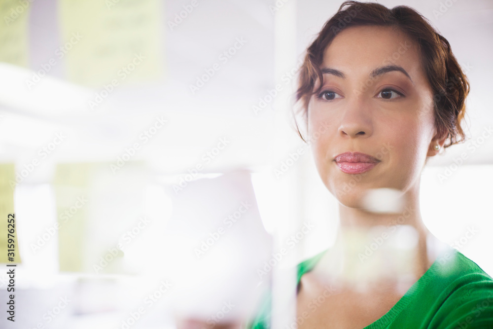 young, adult business woman focussed on chart Stock Photo | Adobe Stock