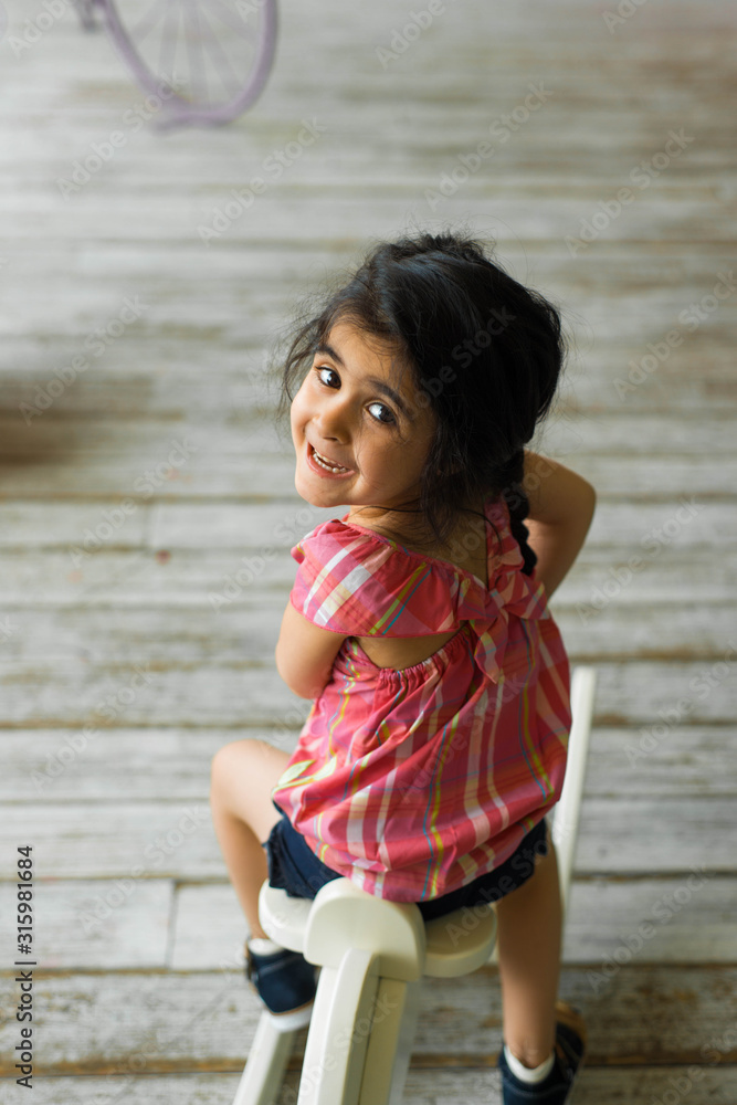 little girl riding a toy horse Stock Photo | Adobe Stock