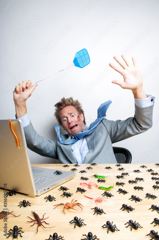 Frightened office worker freaking out at an onslaught of bugs crawling ...