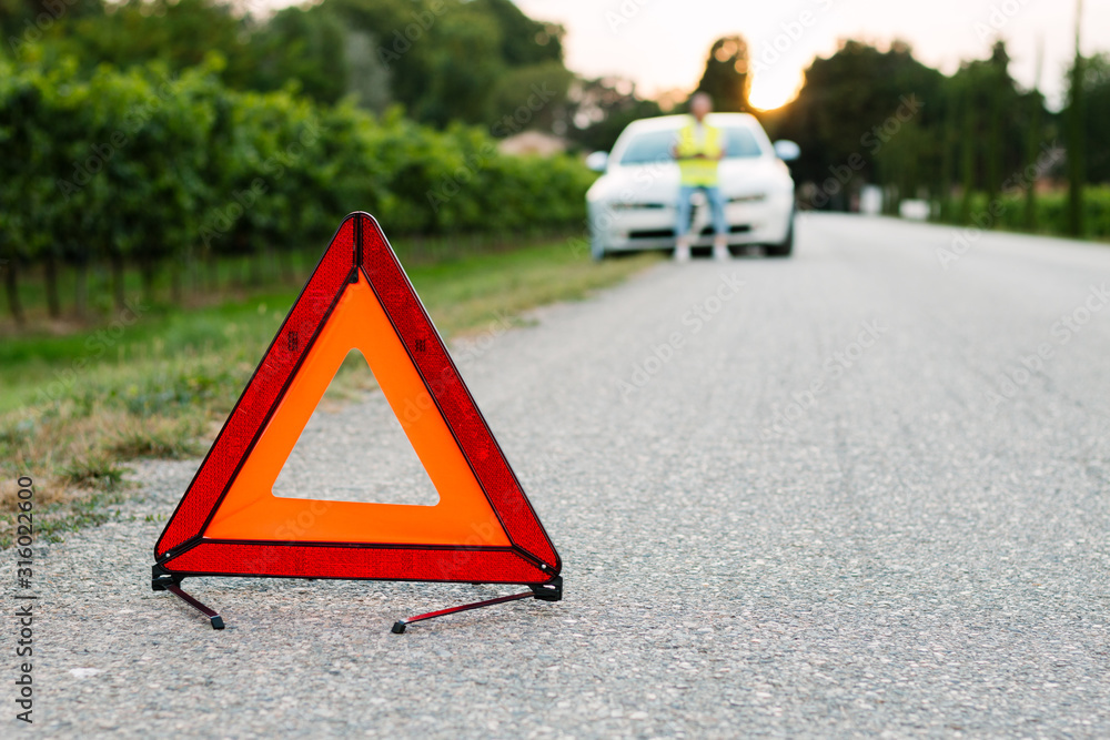 Red emergency stop sign and man waiting the car assistance with broken ...