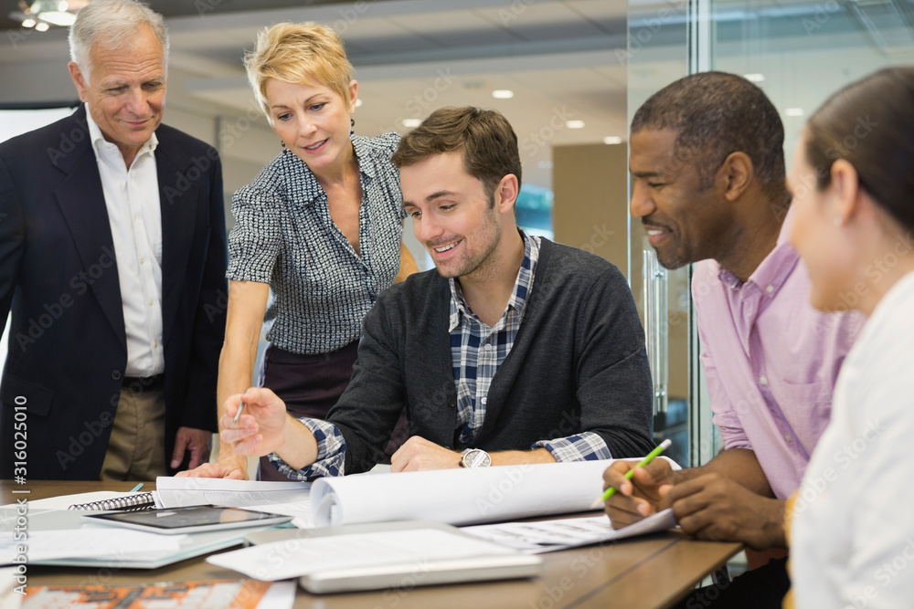 Business colleagues reviewing notes on digital tablet Stock Photo ...