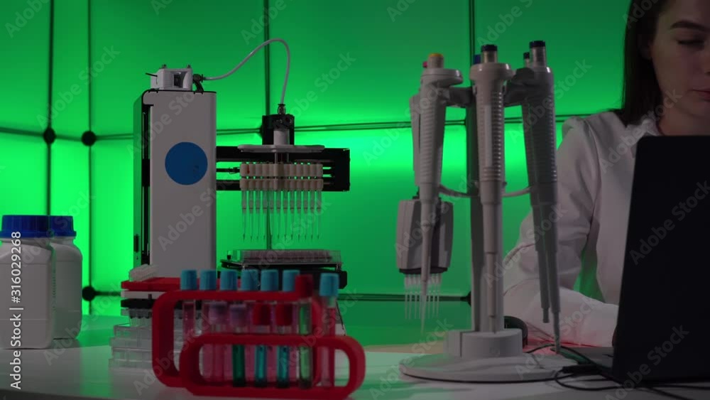 Young woman use Automated DNA Processor real-time PCR cycler. PCR ...