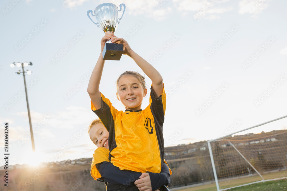 Successful soccer players with trophy Stock Photo | Adobe Stock