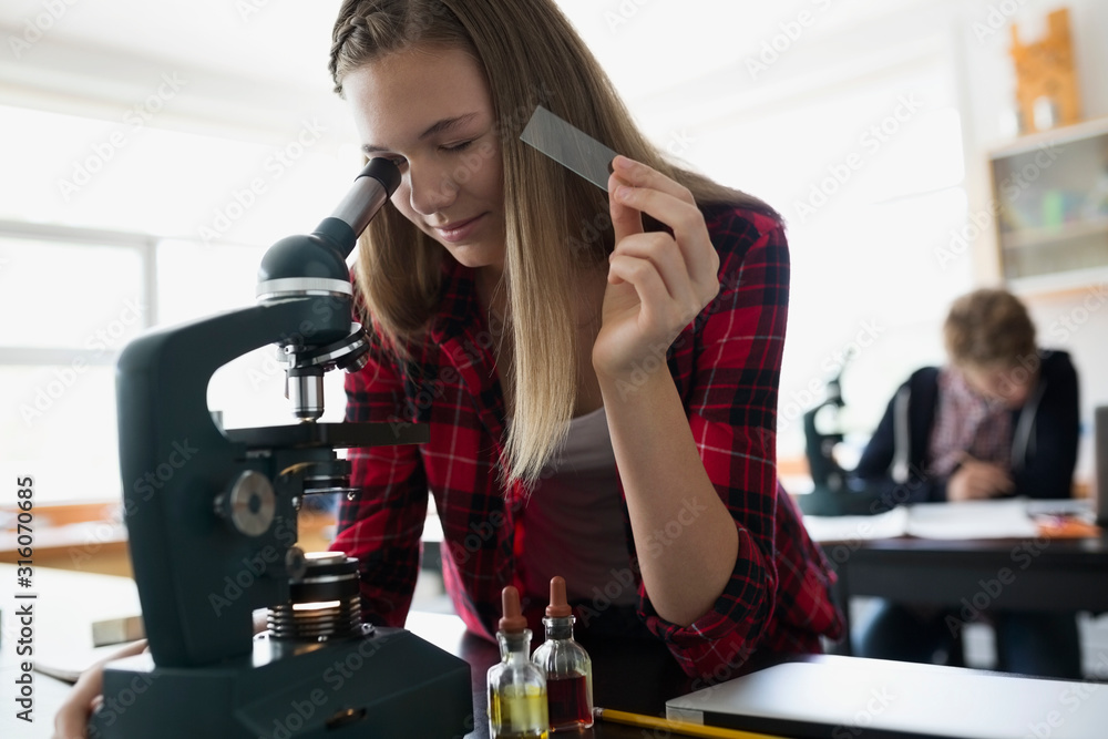 High school student using microscope science laboratory classroom Stock ...