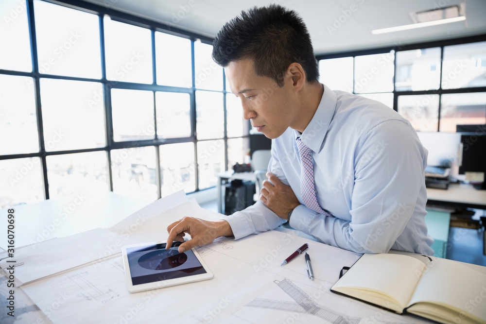 Architect using digital tablets drafting blueprints in office Stock ...