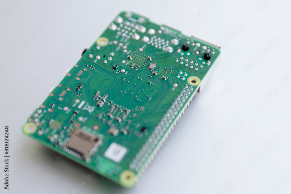 A Raspberry Pi 4 board, isolated on silver background. The Raspberry Pi ...