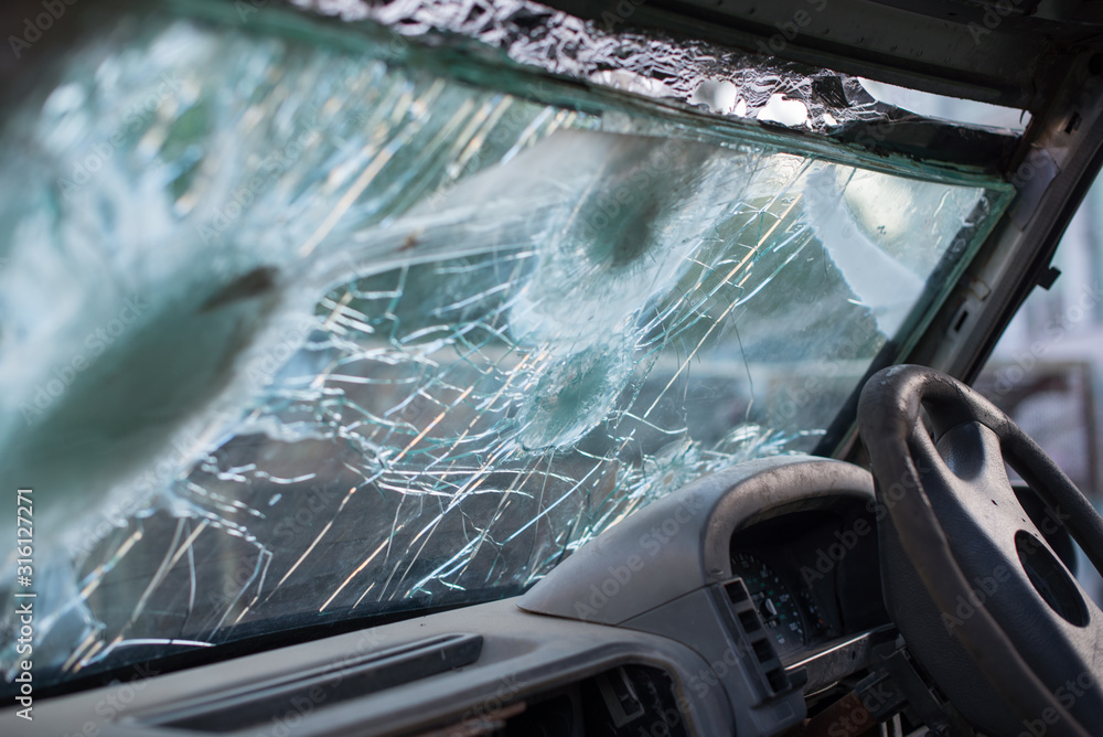 Bullet hole on a car windshield. Car window after a raid has a bullet ...