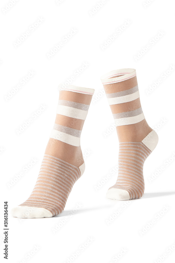 Cropped shot of female feet on tiptoe in the nylon transparent socks ...