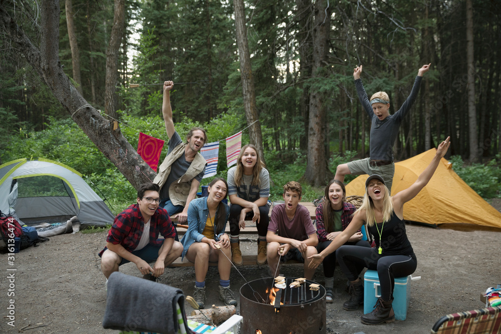 Portrait enthusiastic teachers and teenage outdoor school students ...