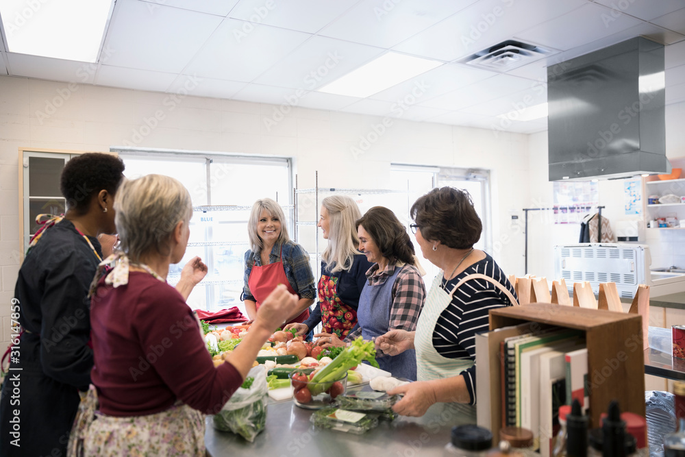 Female volunteers cooking in soup kitchen Stock Photo | Adobe Stock