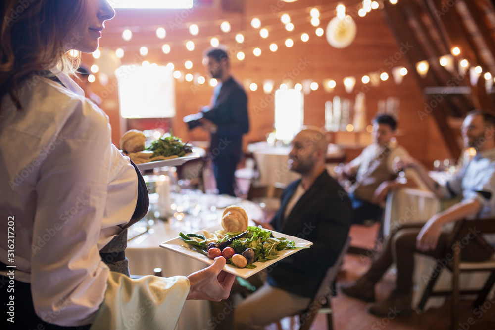 Female server carrying plates of Food at wedding reception Stock Photo ...