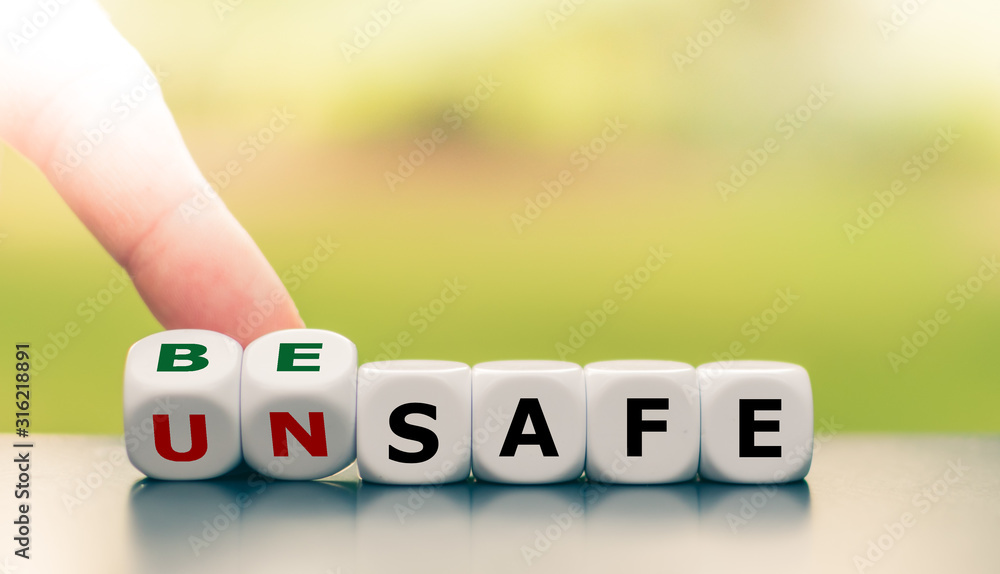 Hand turns a dice and changes the expression "unsafe" to "be safe ...