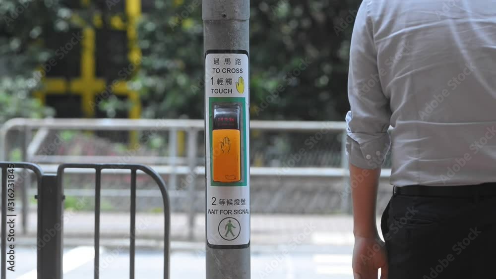 Person man pressing pedestrian crossing signal button at intersection ...
