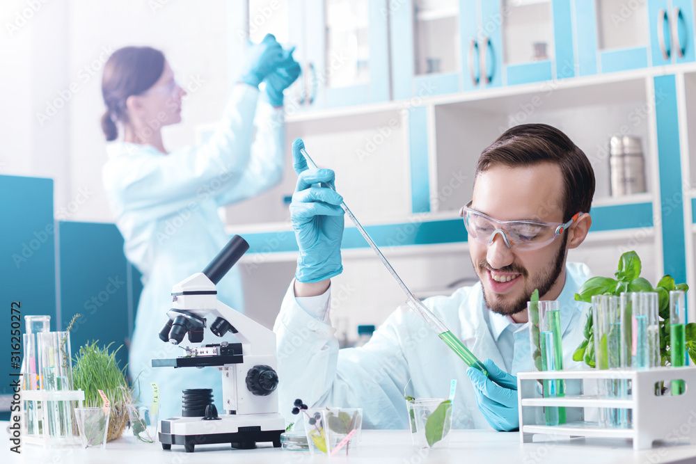 Scientists are working at microbiology laboratory. Man is conducting ...
