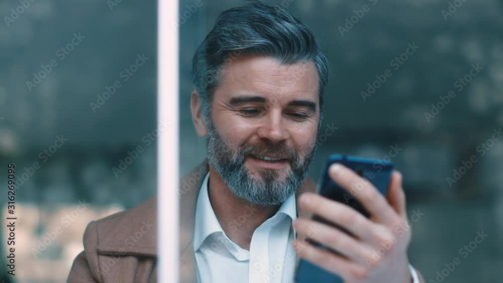 Portrait of attractive middle aged business man in the café, laughing ...