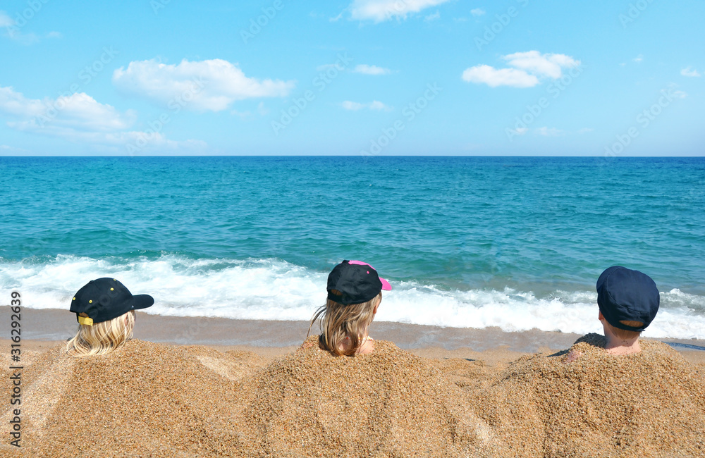 Vacation mode with the kids. Having fun at the beach in Spain in the ...