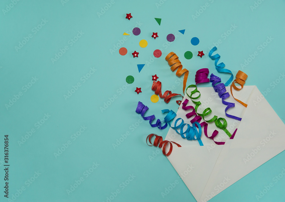 The concept of birthday. Paper ribbons, confetti, and stars fly out of ...
