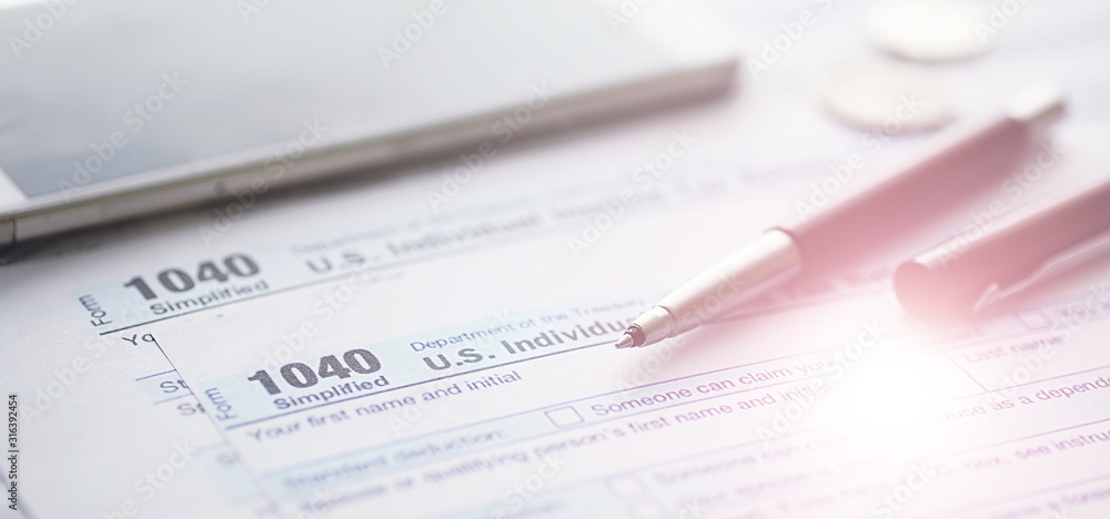 Annual tax reporting. Tax form on the table. Financial statements for ...