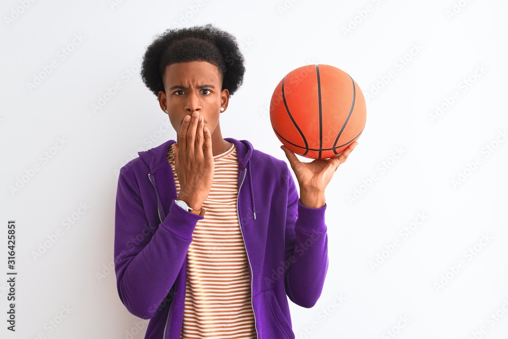 Young african american sportsman holding basketball ball over isolated ...