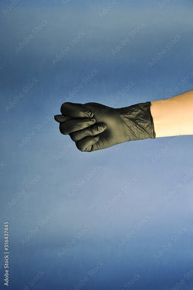 Hands in black latex gloves. To give someone a finger. The thumb ...