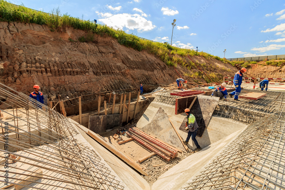 Pile driving in foundation pit for construction of apartment building ...