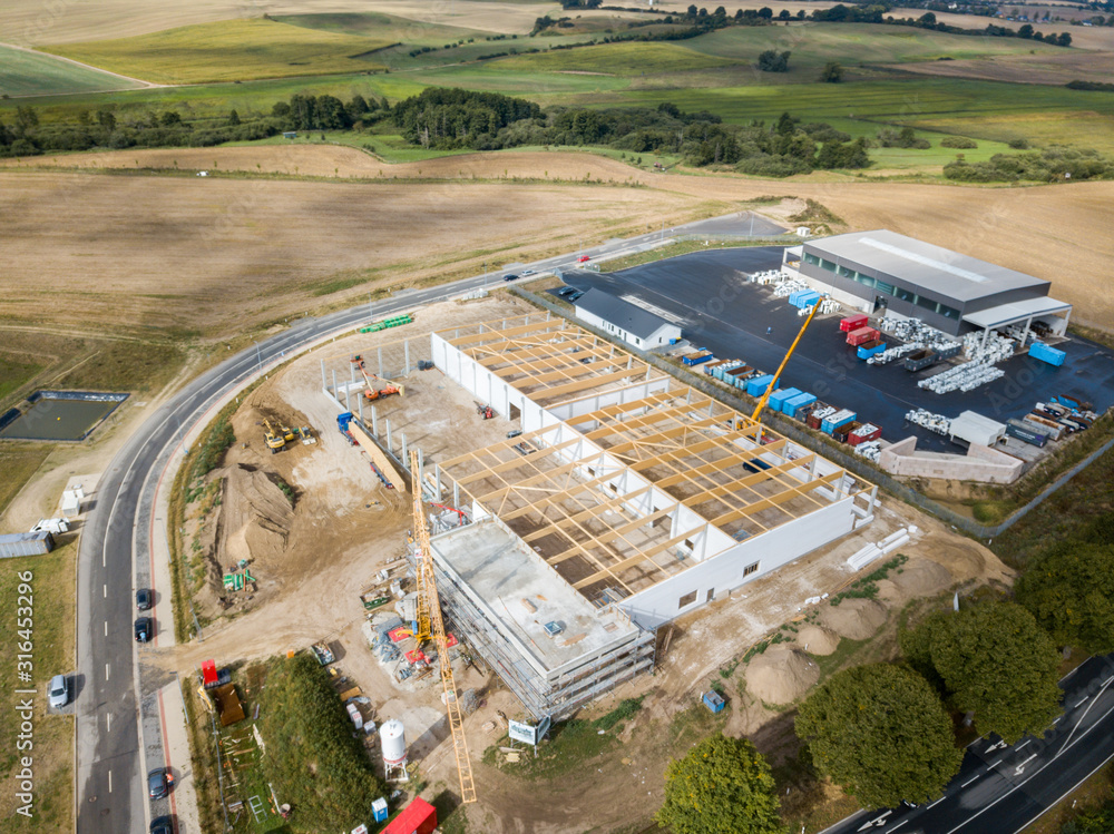 on a building site wooden trusses are built on the concrete columns of ...