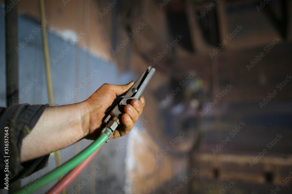 Closeup picture of male hand holding operating safety deadman ...