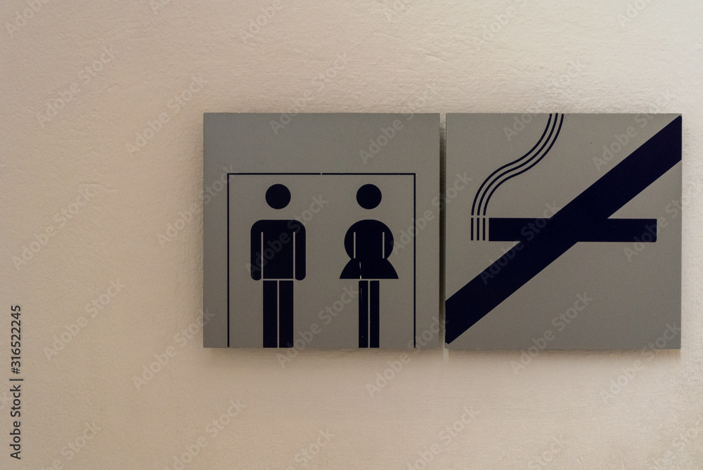 Toilet sign and no smoking sign on the white cement wall Stock Photo ...