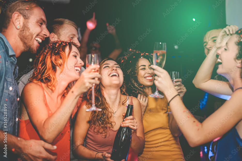 Happy friends doing party drinking champagne in nightclub - Group young ...