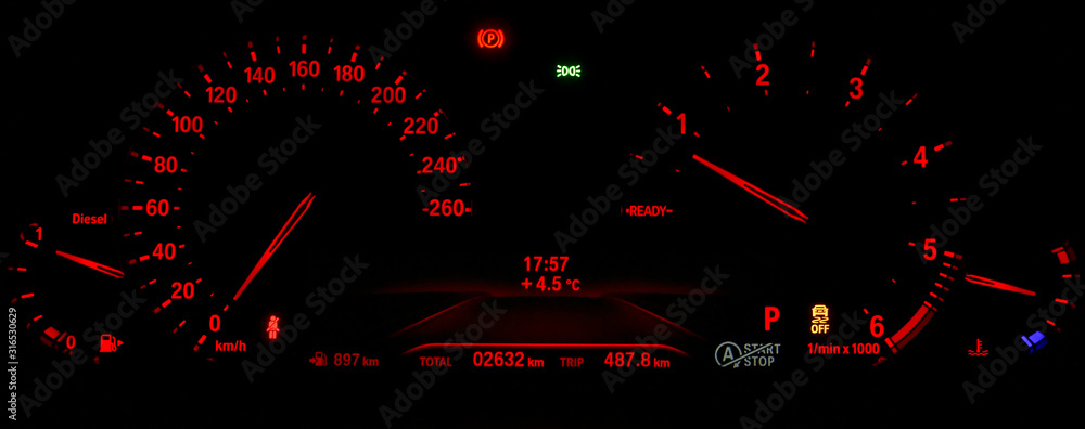 Modern red illuminated instrument cluster with speedometer, tachometer ...