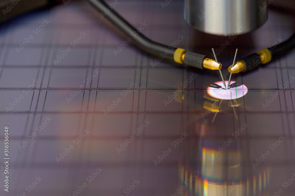 Close up of examining a sample of microchip transistor with probe ...