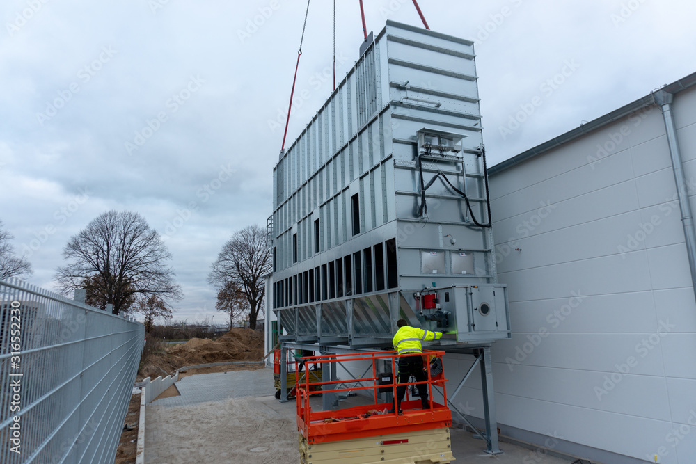 a huge extraction system for wood chips is installed on a factory ...