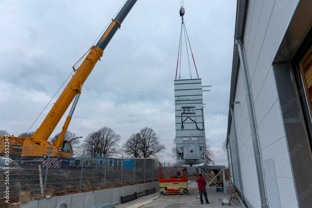 a huge extraction system for wood chips is installed on a factory ...