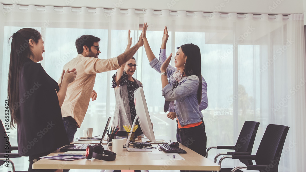 Successful business people group celebrating project success at office ...