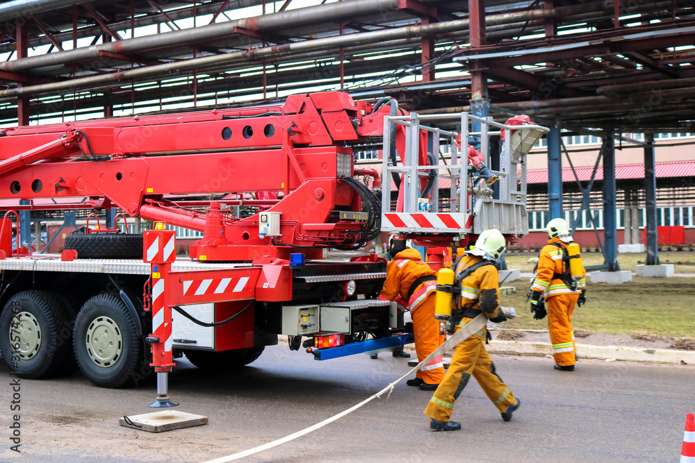 Firemen rescue workers in fireproof suits came to extinguish a fire in ...