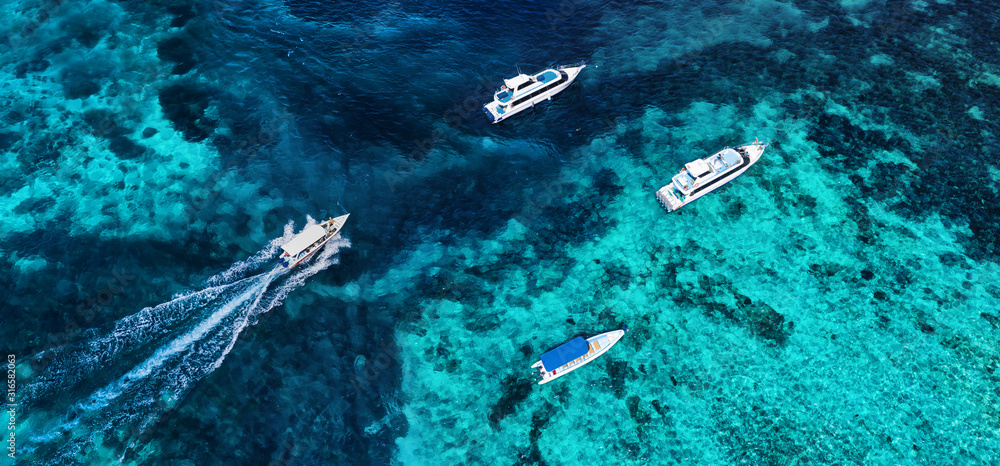 Boats on the water surface from top view. Azure water background from ...