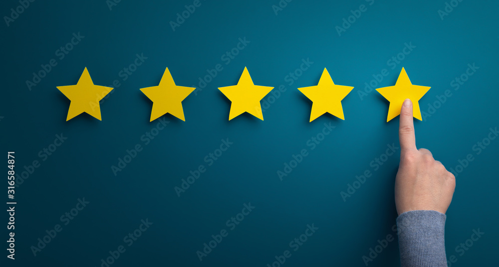 Woman hand point at five star rating on green background Stock Photo ...
