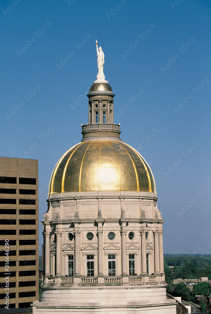 This is the dome of the State Capitol building. It is gold in color ...